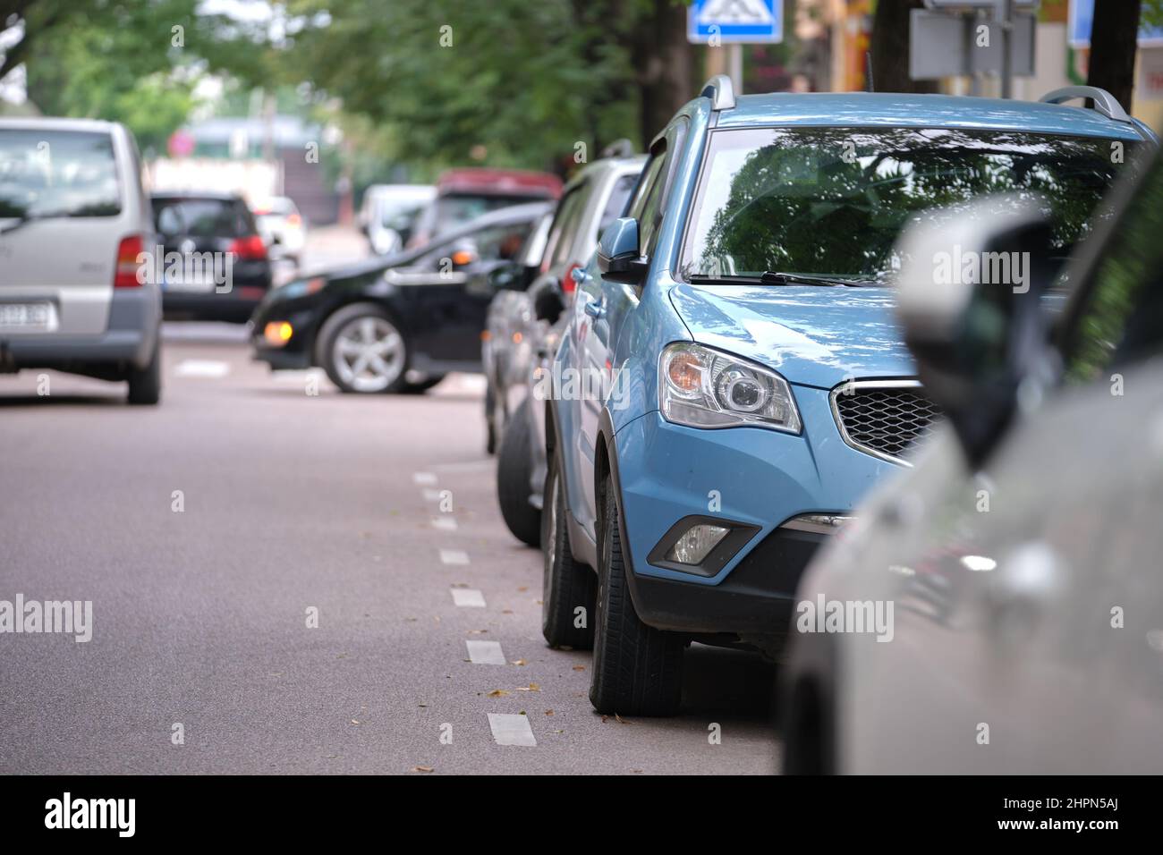 Cars parked in line on city street side. Urban traffic concept Stock ...