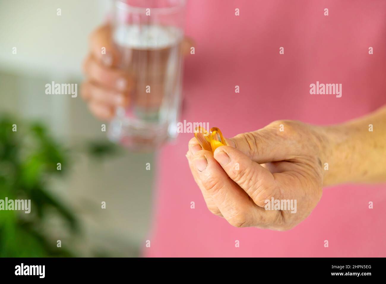 Omega 3 old woman drinks. Selective focus Stock Photo - Alamy