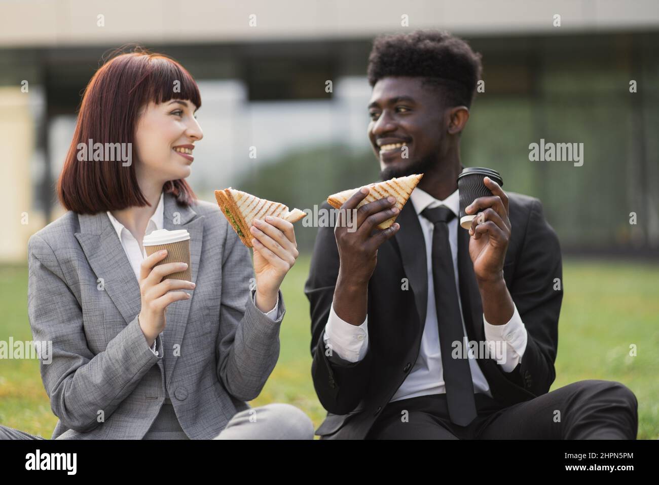 Closeup of joyful multiethnic business people, having lunch together ...