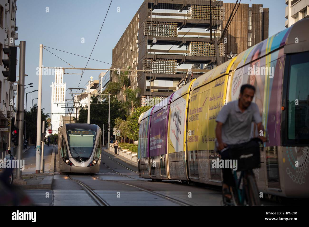 Cyclist and public city passenger tramway on the streets of Rabat ...