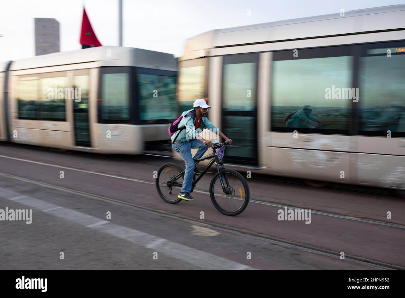 Cyclist and public city passenger tramway on the streets of Rabat ...