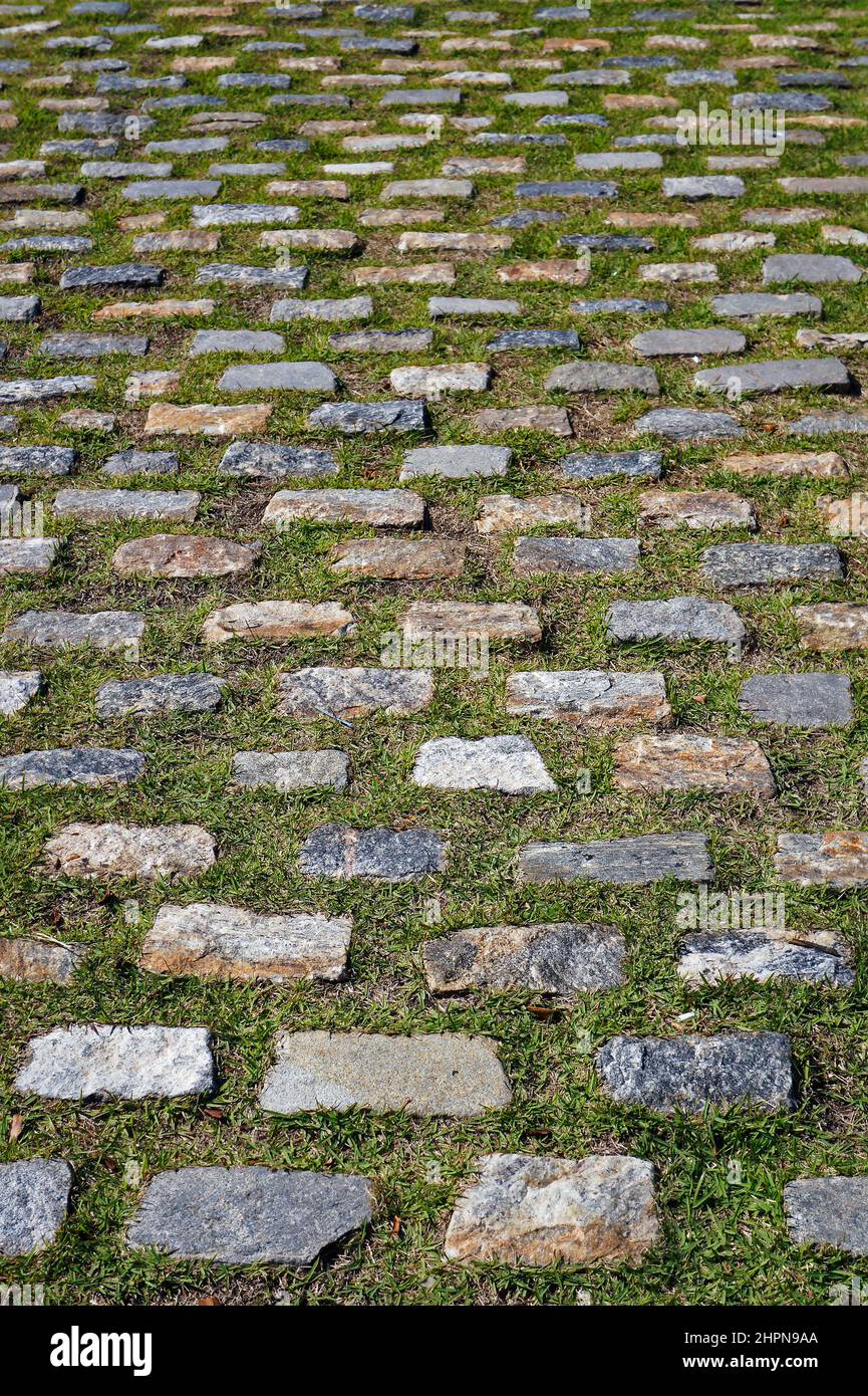 Cobblestone with grass background, Rio Stock Photo - Alamy