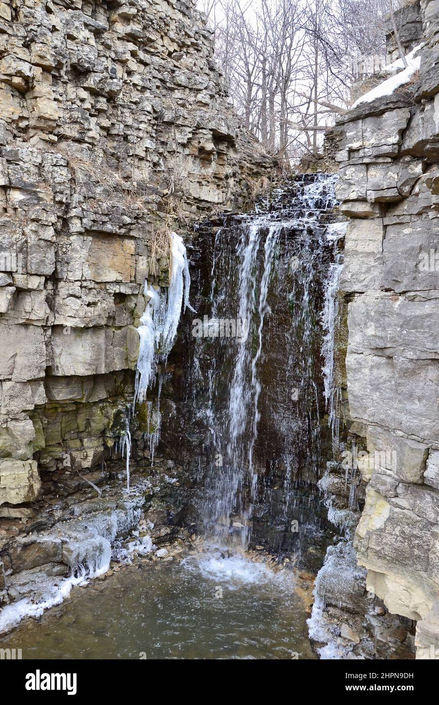 Princess Falls flowing through gap in limestone cliff during Winter ...