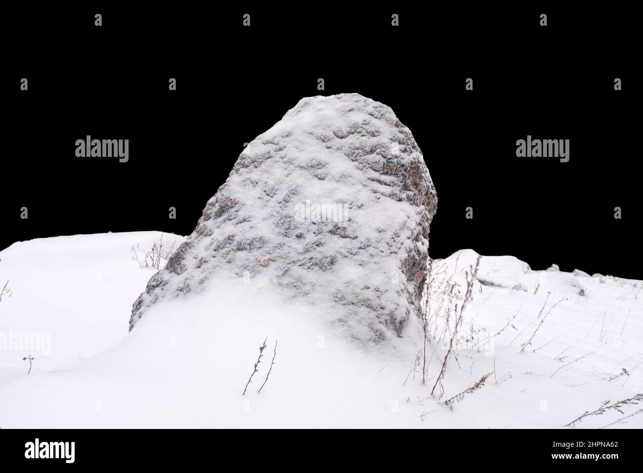 natural stone in snow isolated on black background. High quality photo ...