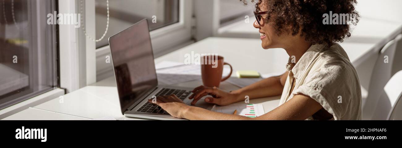 African American woman concentrated looking at computer screen Stock ...