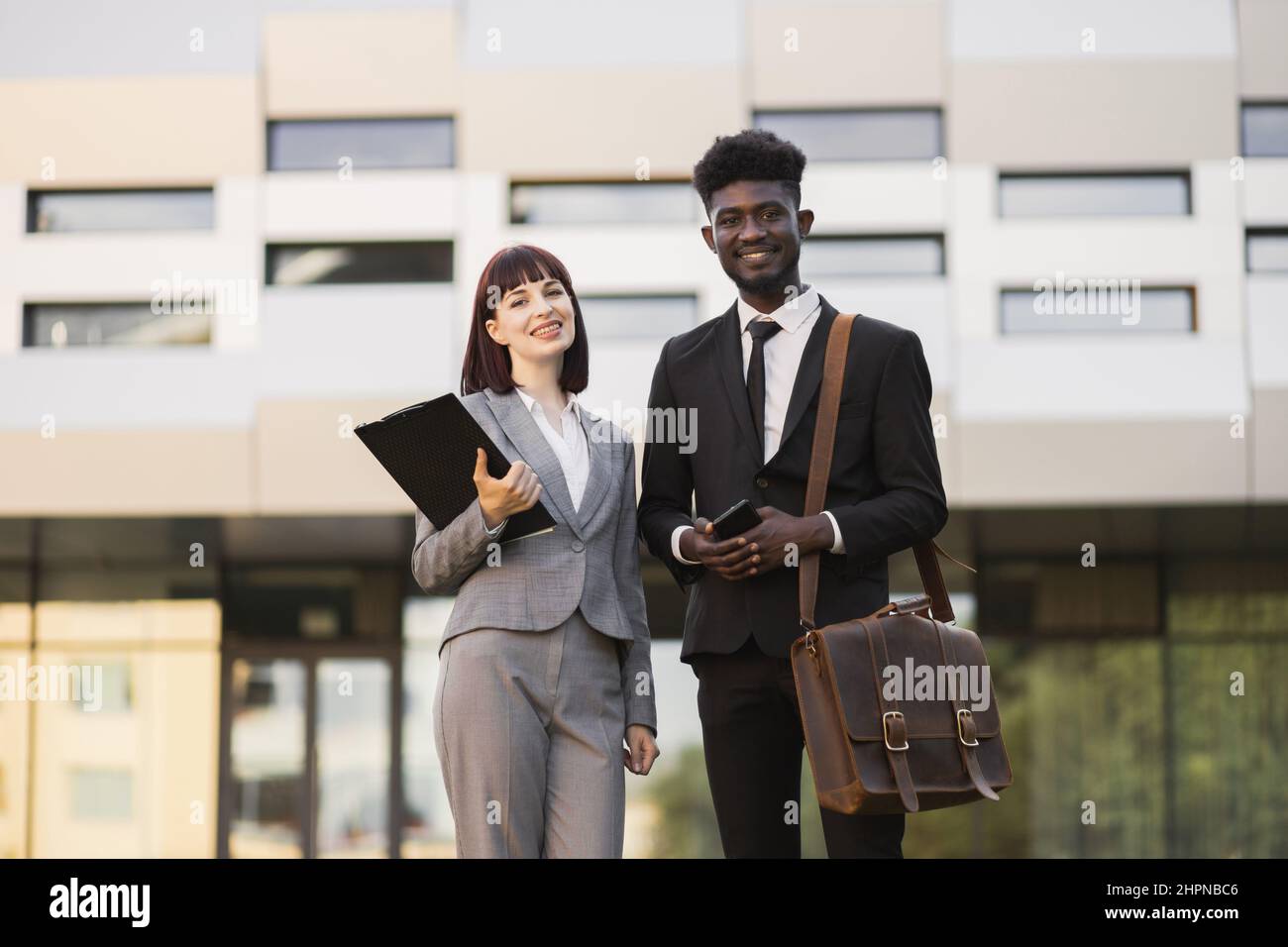 Multiethnic business partners standing outside hi-res stock photography ...
