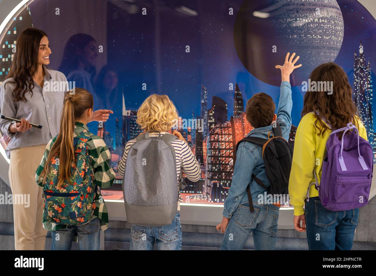 Joyful woman and children standing near screen Stock Photo - Alamy