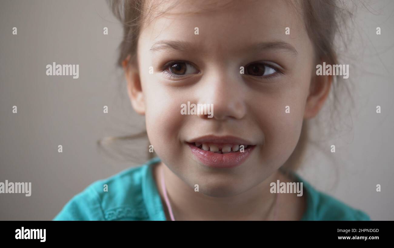 Portrait Funny Happy little kid close up happy preschool girl smiling child looking at camera ...