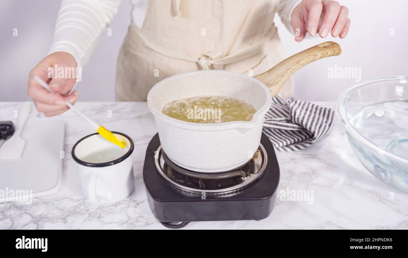 Step by step. Caramelizing sugar in a small cooking pot over the small ...