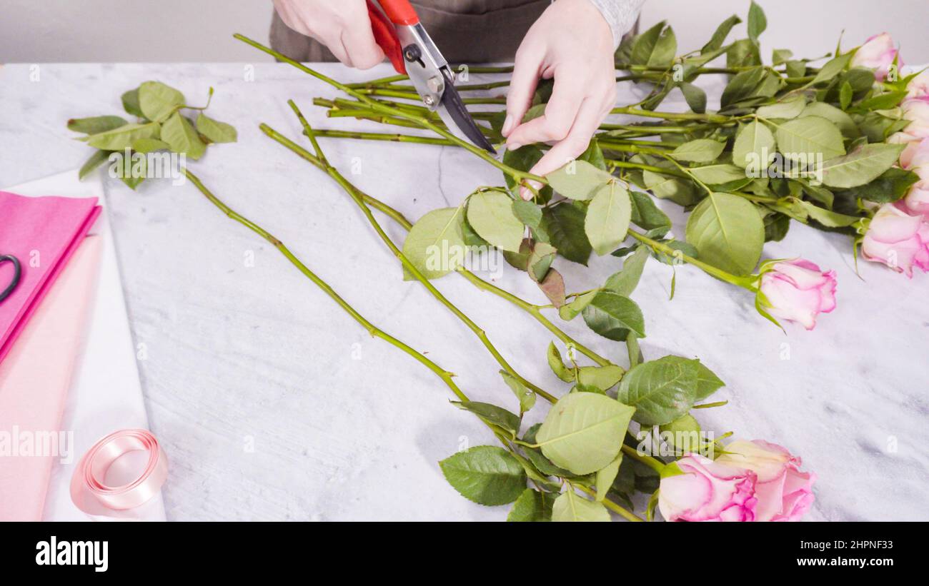 Step by step. Florist arranging a bouquet from pink roses Stock Photo ...