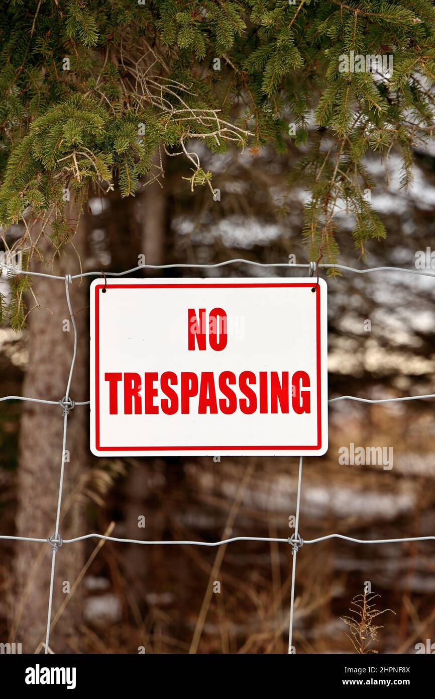 No Trespassing Sign Posted on a Wire Fence in a Rural Setting Stock ...