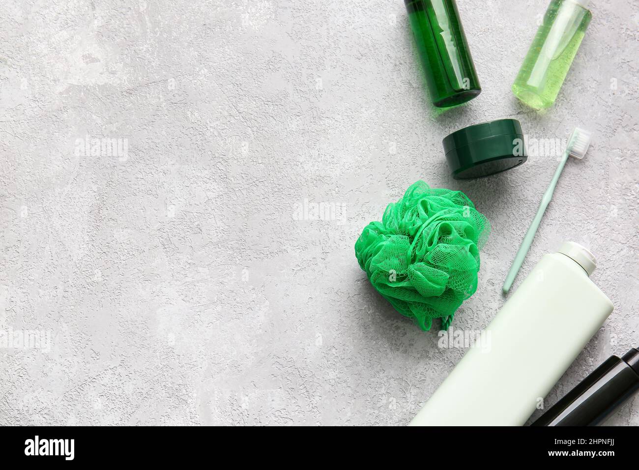 Cosmetic products, toothbrush and sponge on light background Stock ...