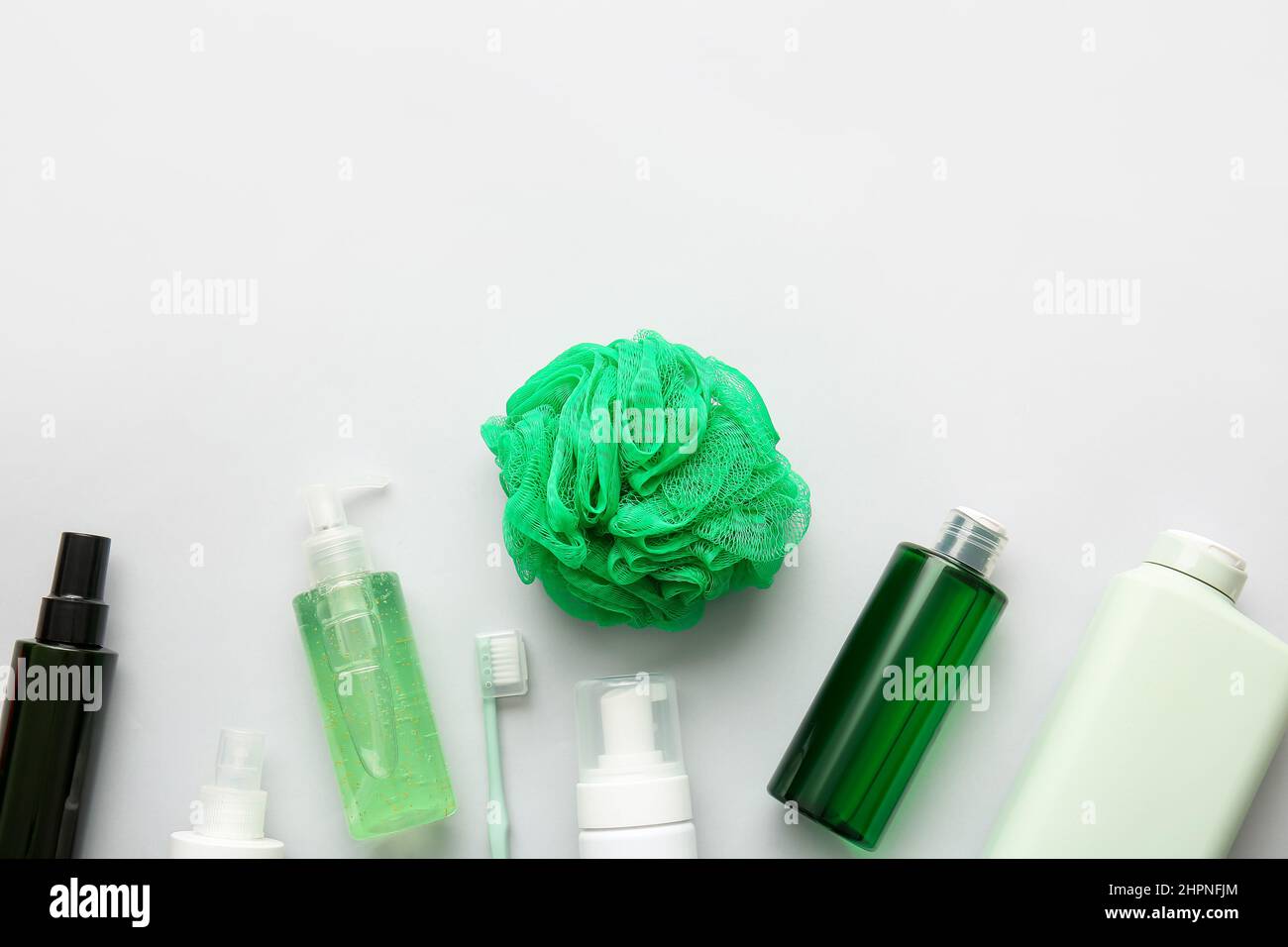 Set of cosmetic products, toothbrush and bath sponge on white ...