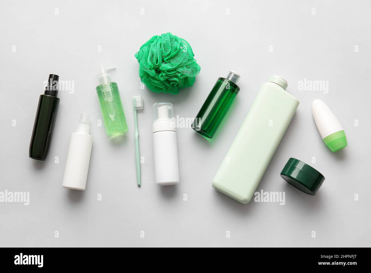 Set of cosmetic products, toothbrush and bath sponge on white ...