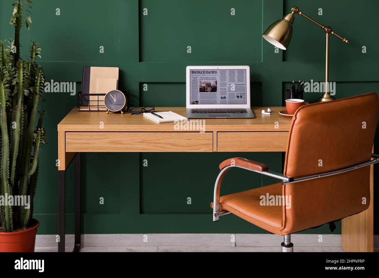Modern workplace with laptop in room Stock Photo - Alamy