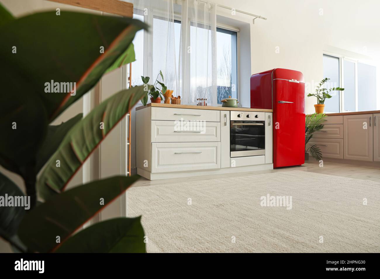 Interior of modern kitchen with red fridge and oven Stock Photo - Alamy