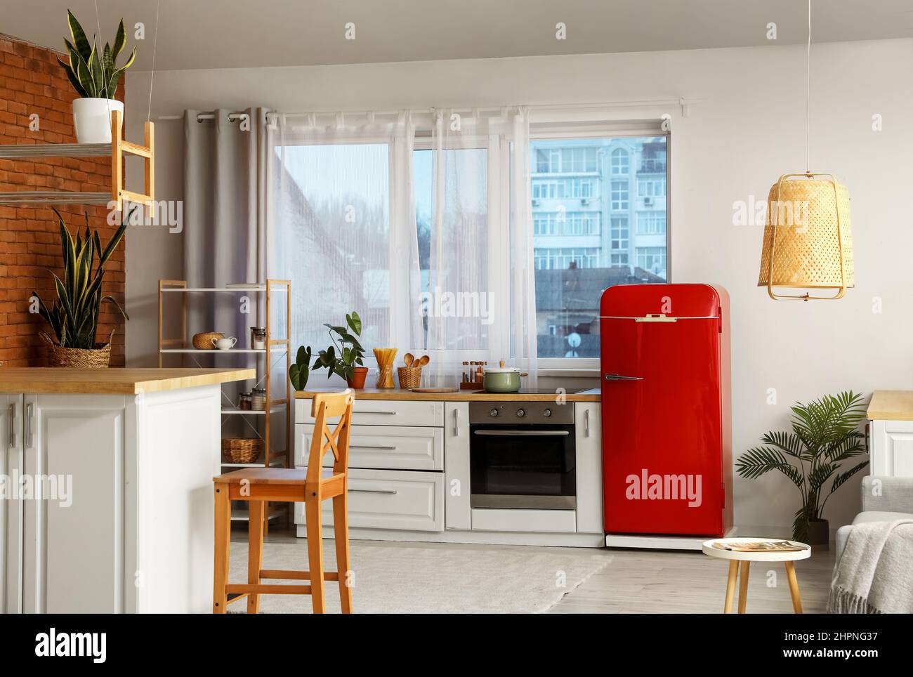 Interior of modern kitchen with red fridge and oven Stock Photo - Alamy
