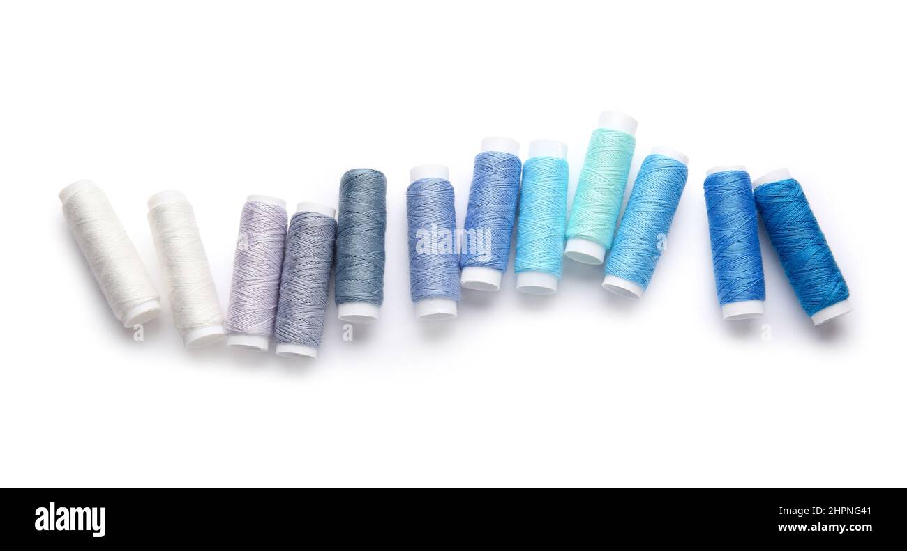 Different thread spools on white background Stock Photo - Alamy