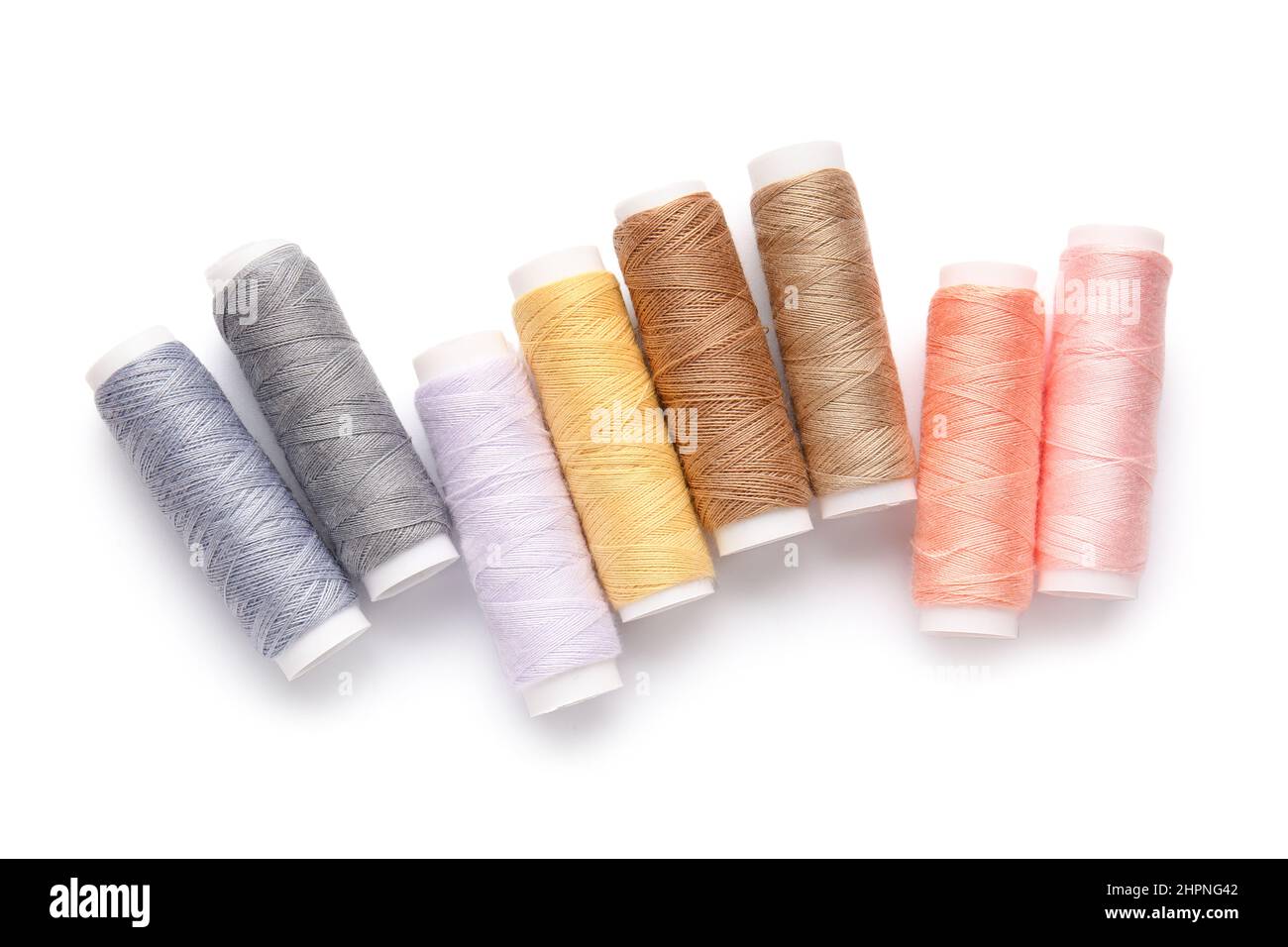 Different thread spools on white background Stock Photo - Alamy