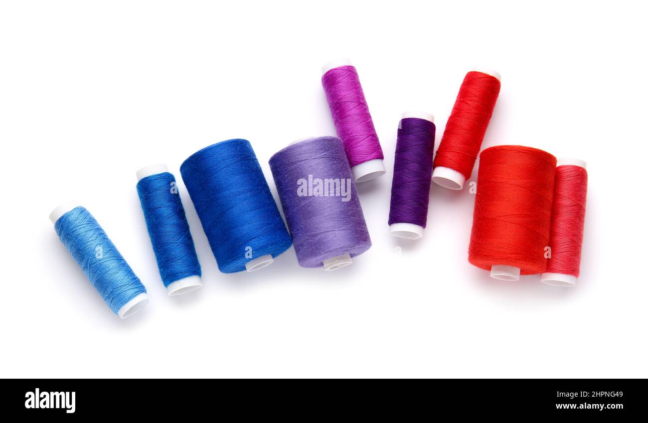 Different thread spools on white background Stock Photo - Alamy