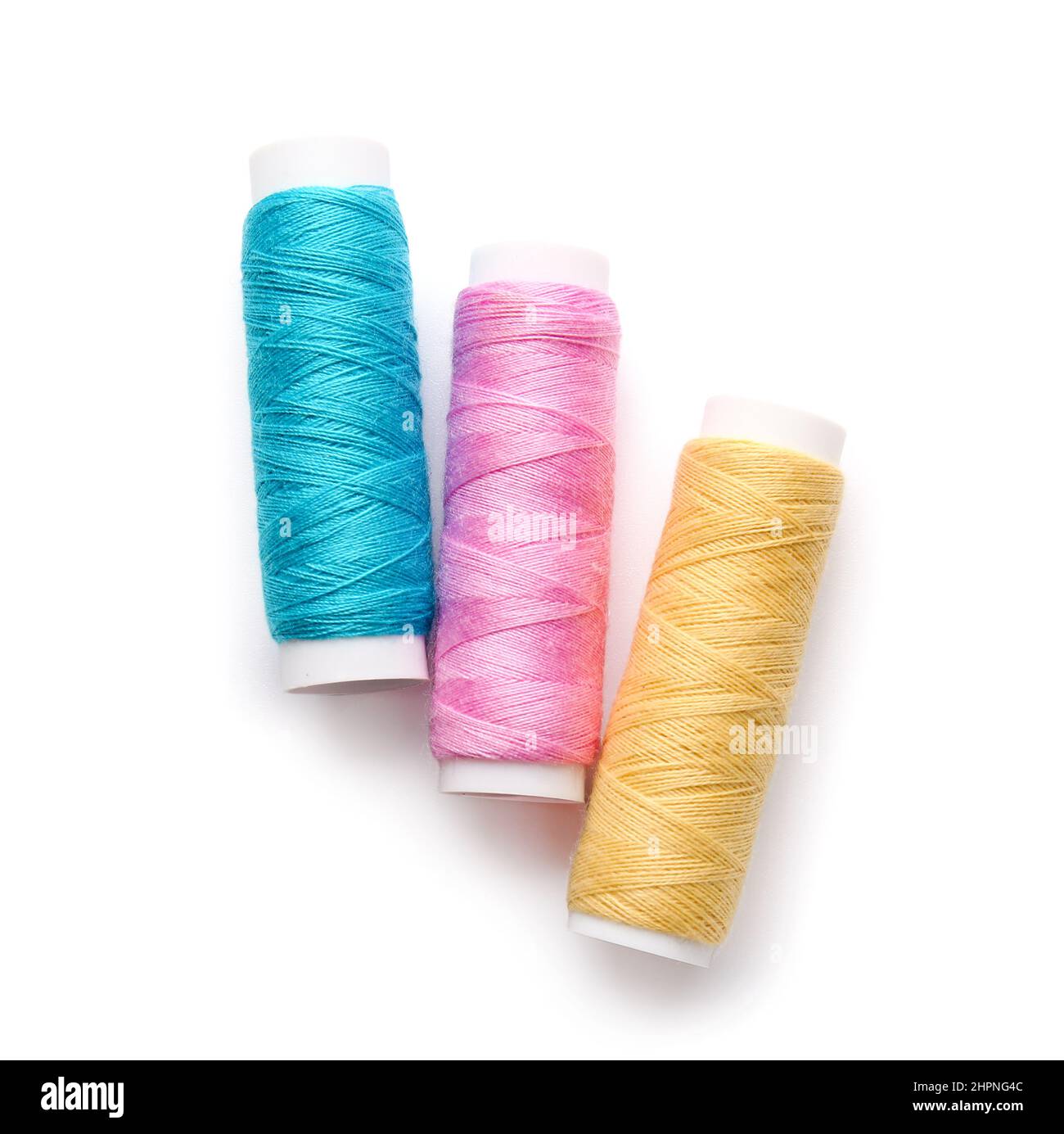 Different thread spools on white background Stock Photo - Alamy