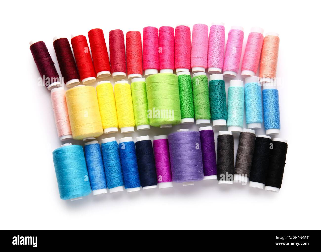 Different thread spools on white background Stock Photo - Alamy
