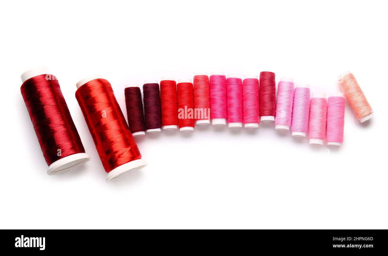 Different thread spools on white background Stock Photo - Alamy