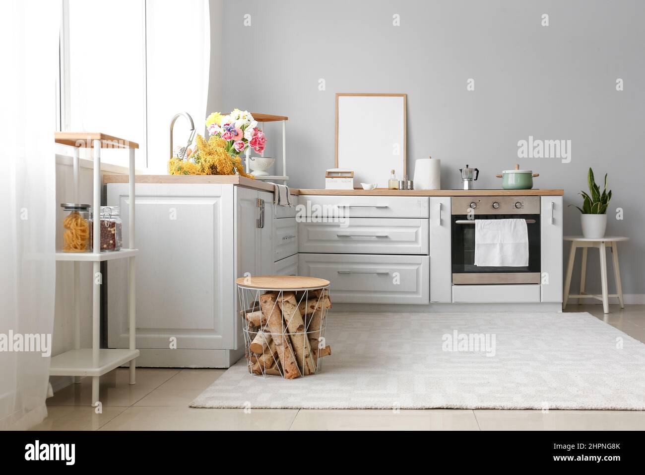 Stylish interior of kitchen with beautiful flowers Stock Photo - Alamy