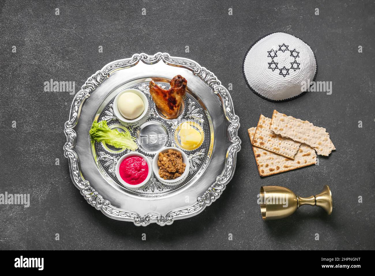 Passover Seder plate with traditional food, cup, matza and kippah on ...
