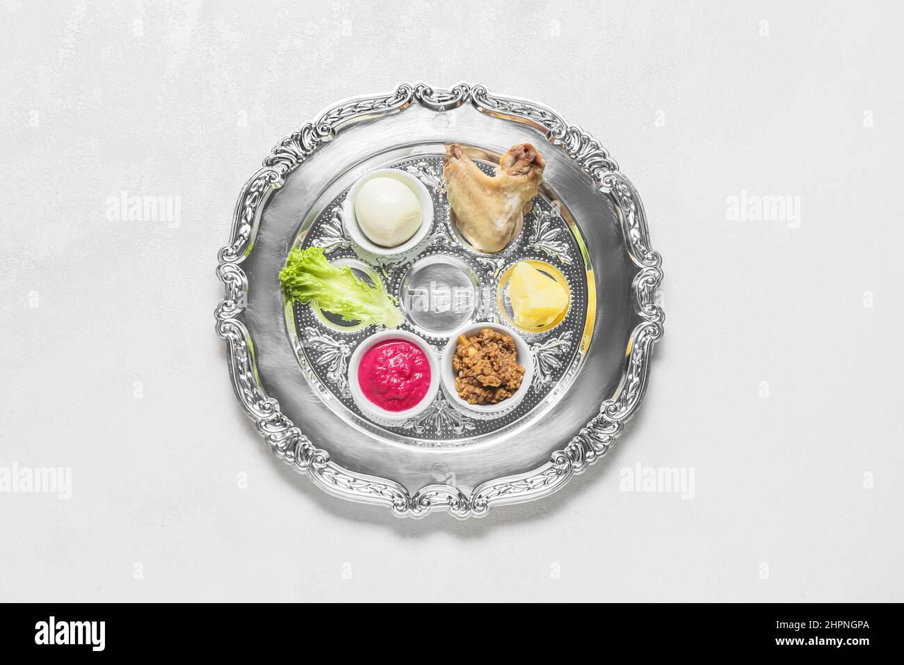 Passover Seder plate with traditional food on white background Stock ...