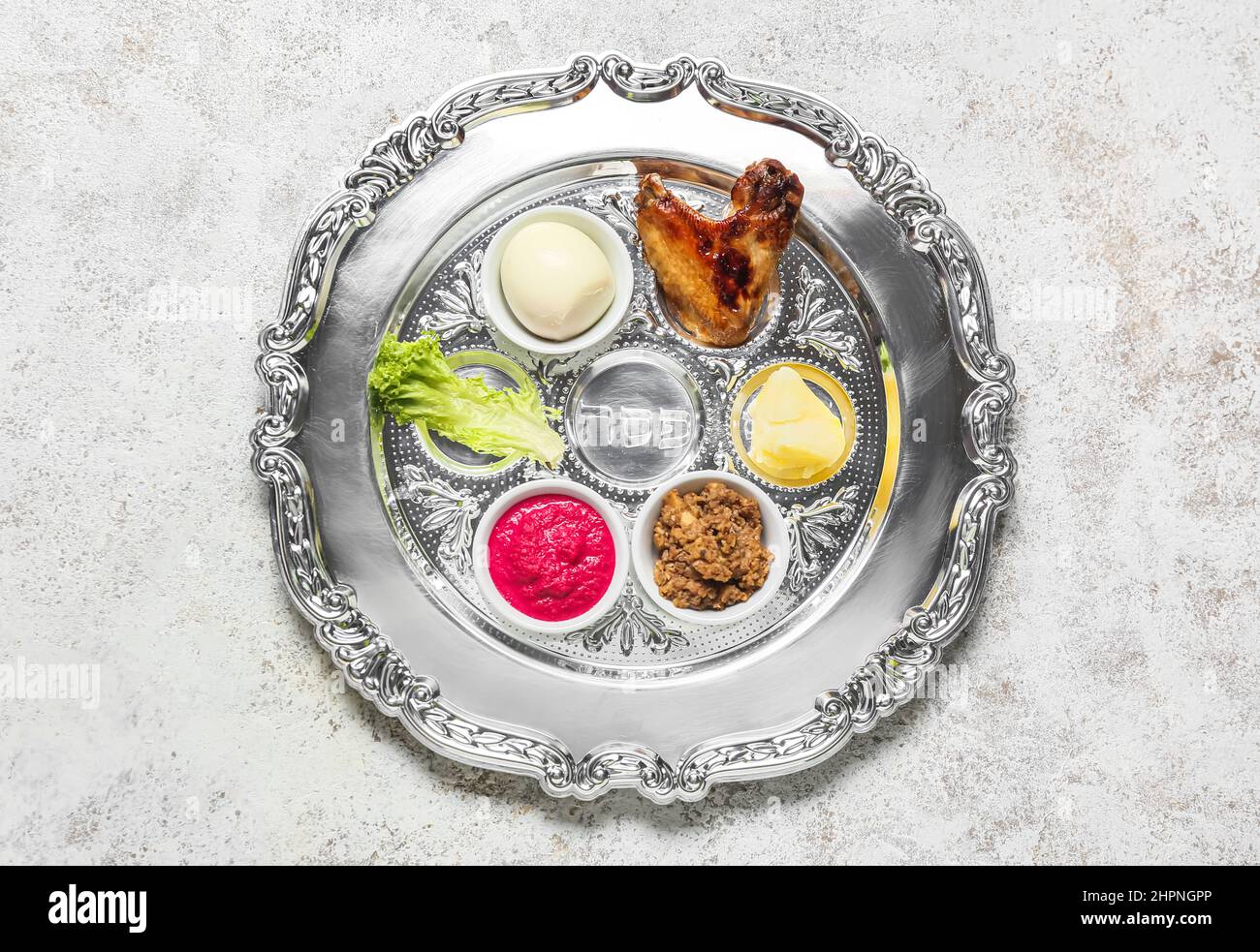 Passover Seder plate with traditional food on light background Stock ...
