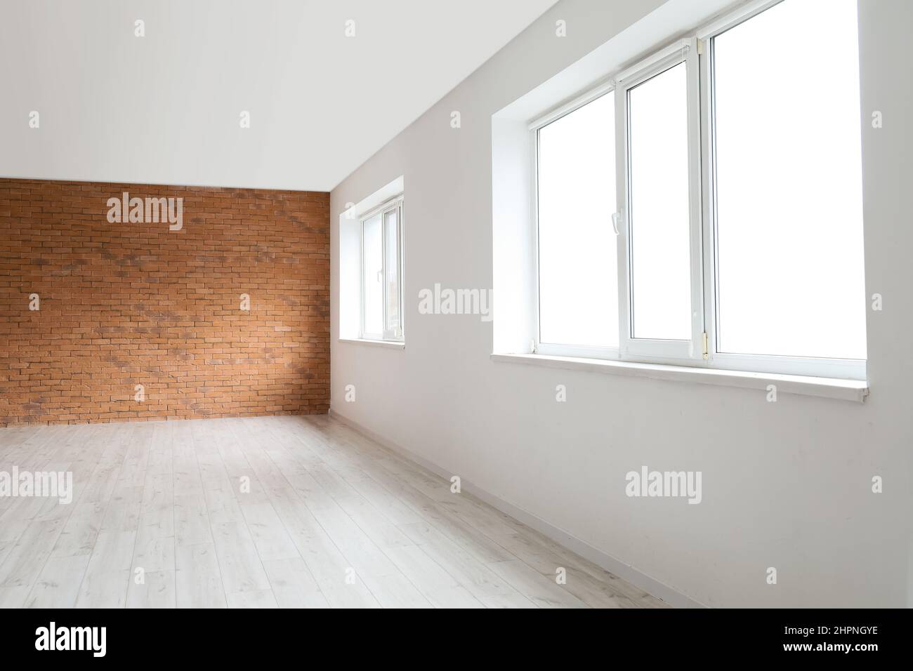 View of big empty room with windows, light and brick walls Stock Photo ...