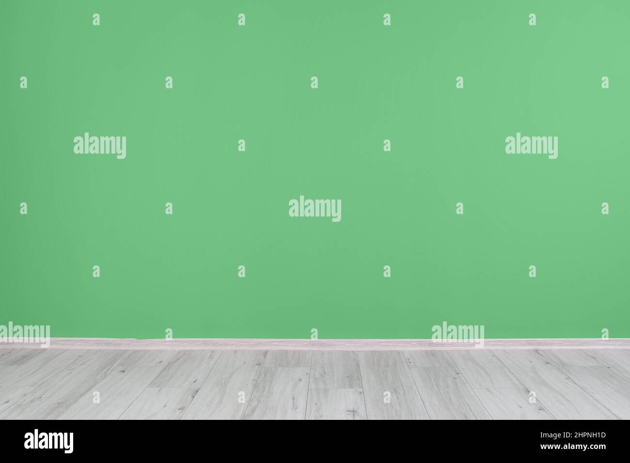 View of green wall in big empty room Stock Photo - Alamy