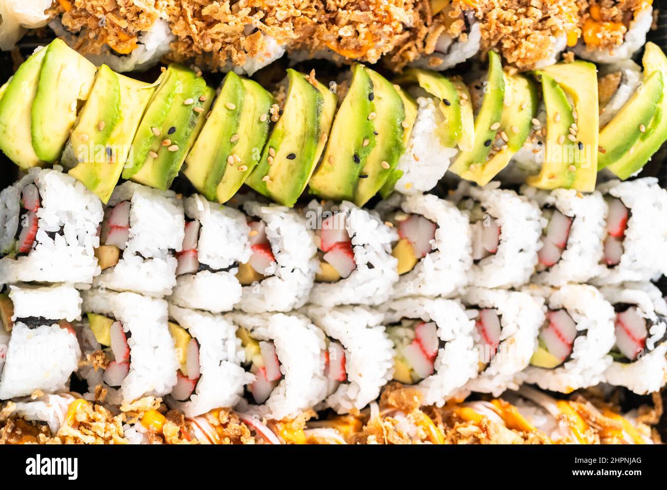 Pre-packaged variety of sushi and sushi rolls in a plastic tray Stock ...