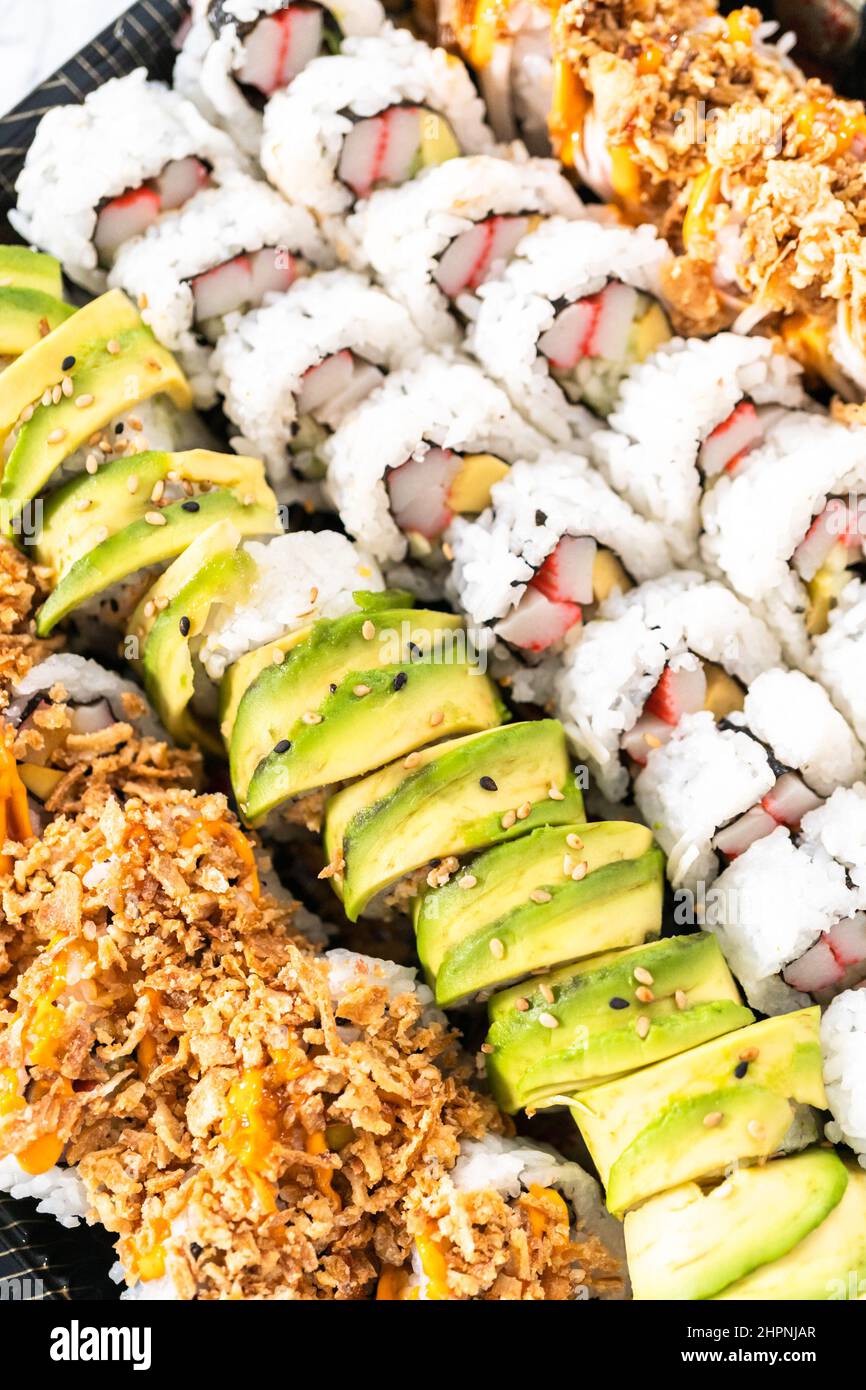 Pre-packaged variety of sushi and sushi rolls in a plastic tray Stock ...