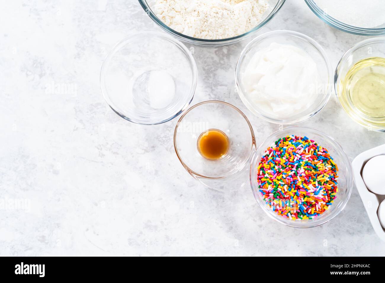 Ingredients in glass mixing bowls to bake funfettti bundt cake Stock ...