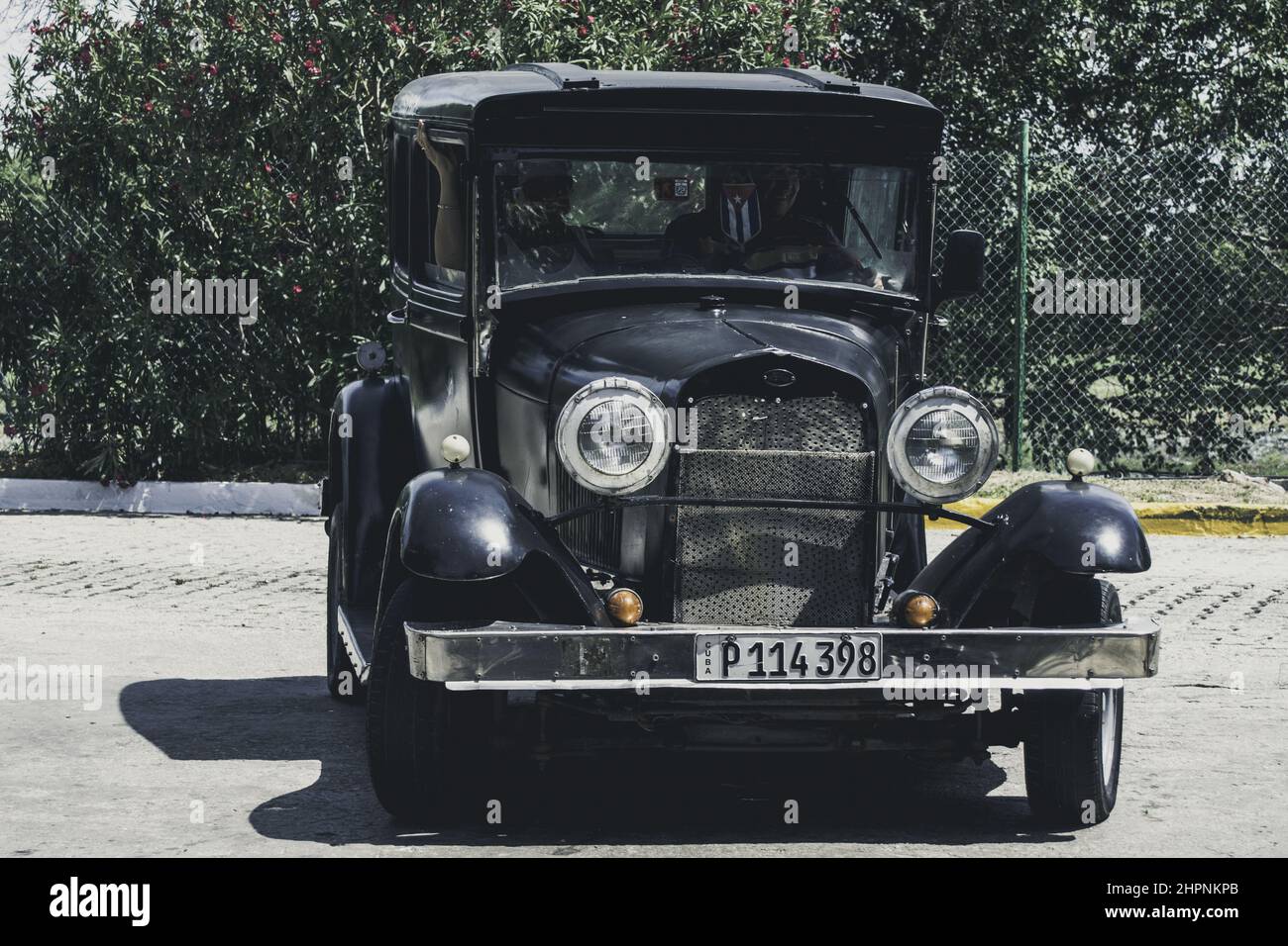 Old and historic car famous and original model in the museum with trees ...