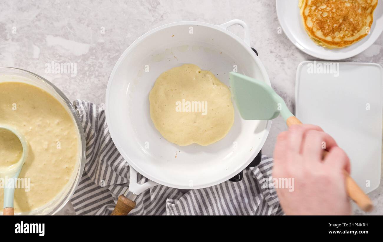 Flat lay. Step by step. Frying coconut banana pancakes on a nonstick ...