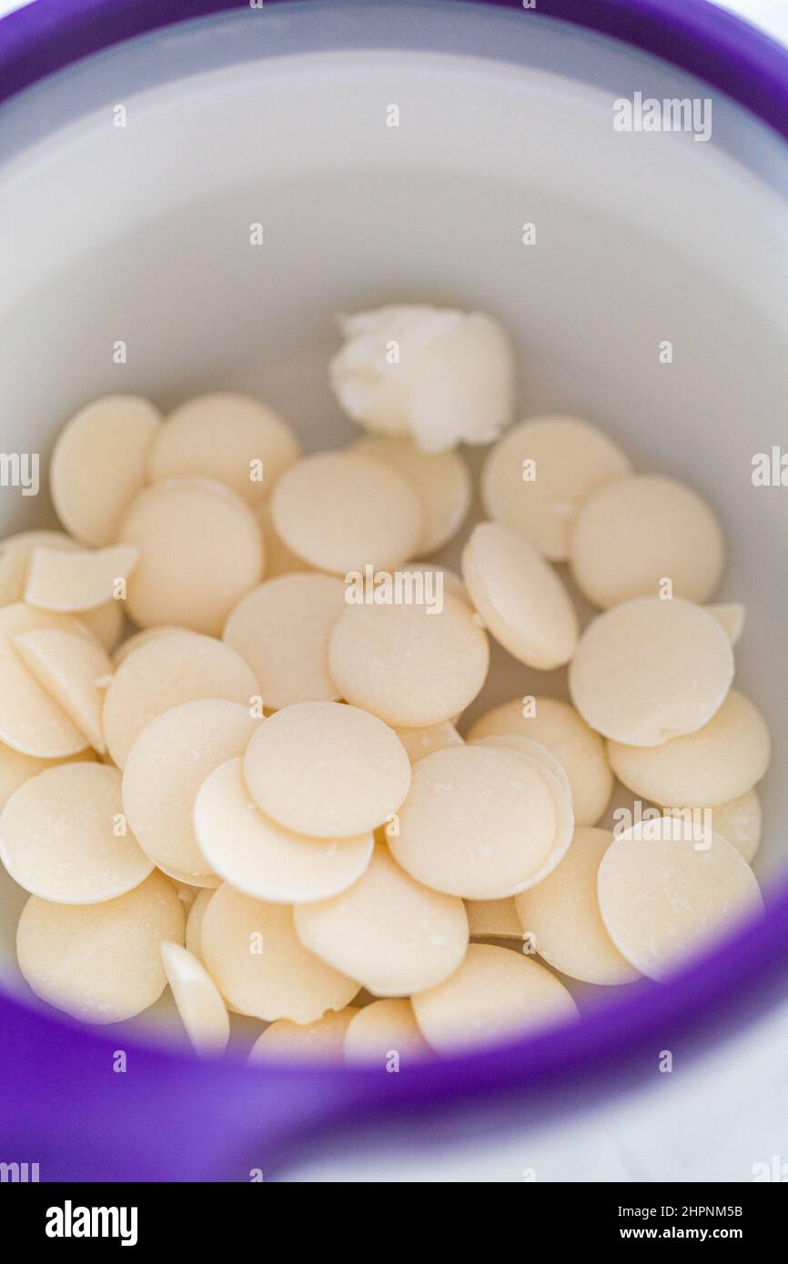 Melting white chocolates to make white chocolate stars Stock Photo - Alamy