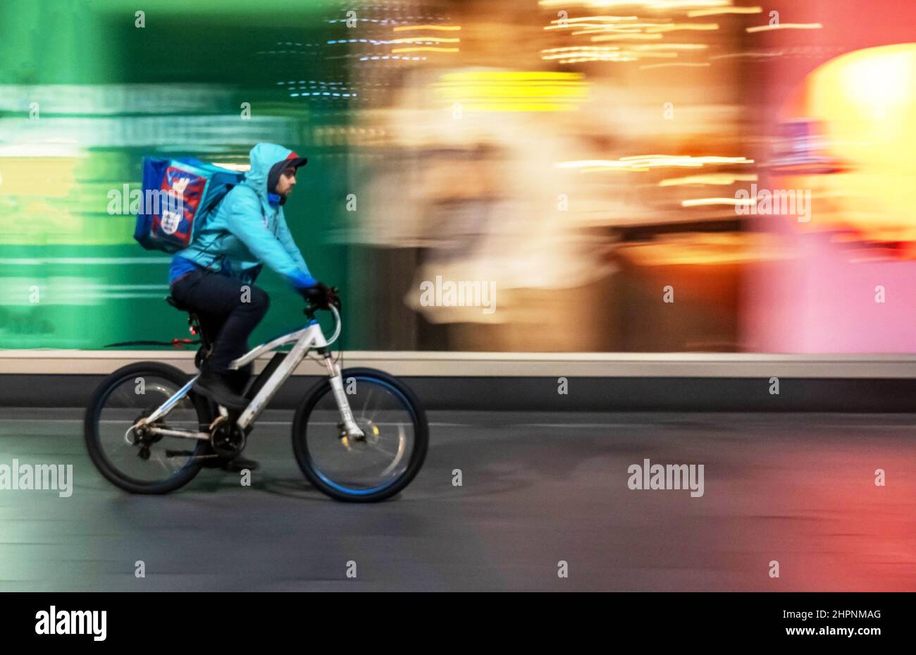 Deliveroo bicycle delivery worker speeding at night BHZ Stock Photo - Alamy