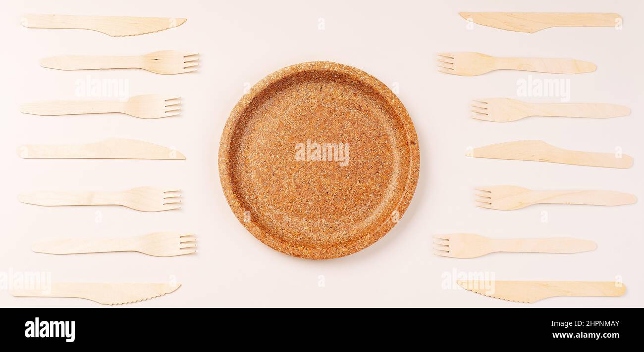 Disposable cutlery on a pressed paper plate on a background.Eco ...