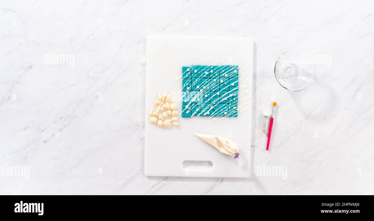 Flat lay. Drizzling melted white chocolate and sprinkling with white ...