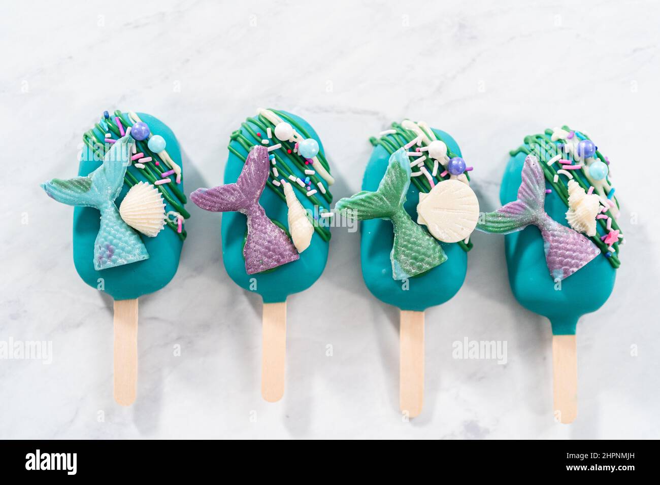 Mermaid cakesicles with drizzled chocolate, chocolate mermaid tails ...