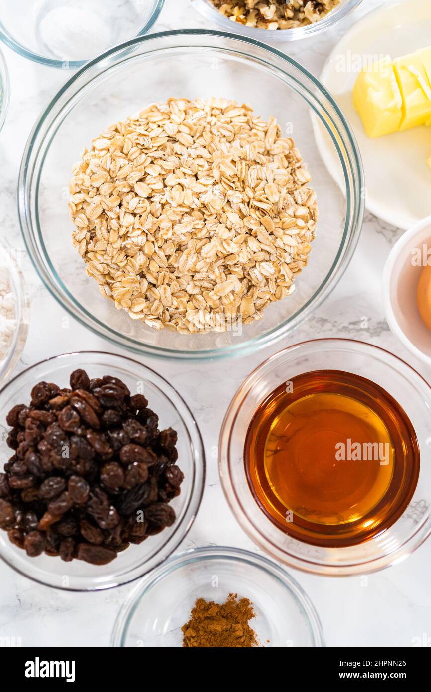 Measured ingredients in glass mixing bowls to bake soft oatmeal raisin ...