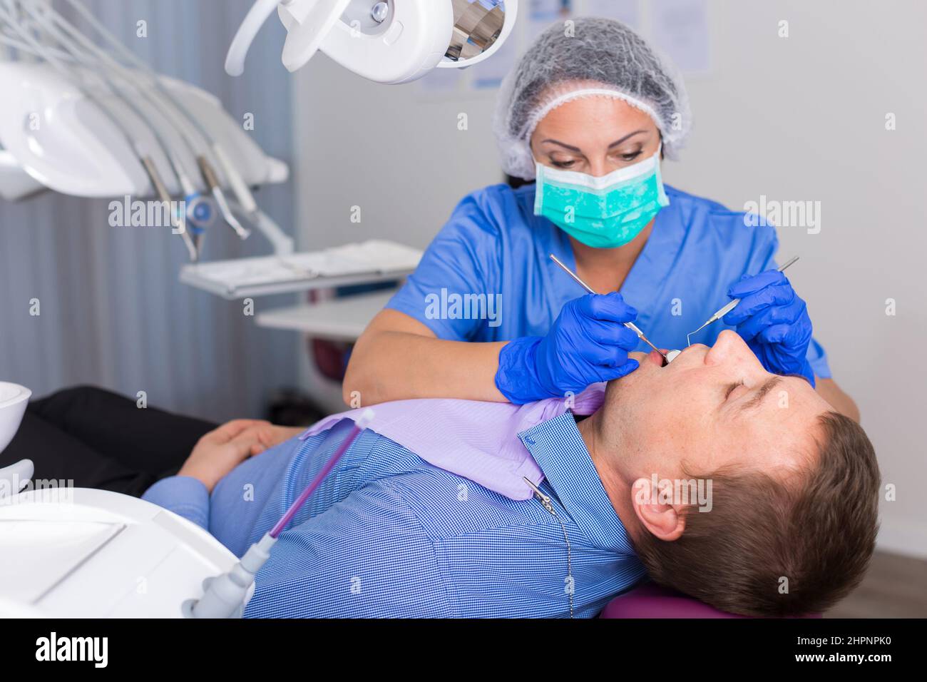 adult dentist checking teeth of patient Stock Photo - Alamy