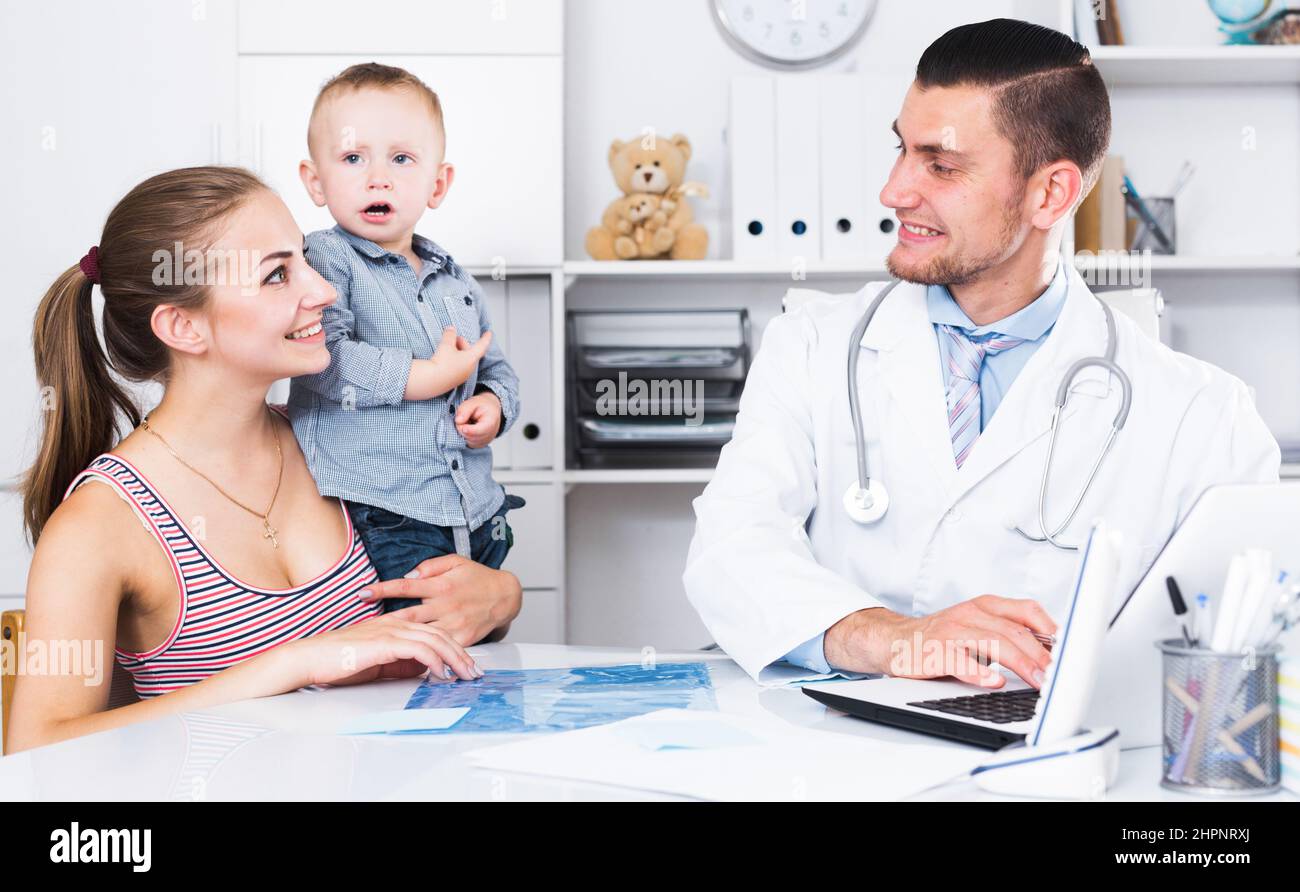 Adult male doctor leading medical appointment Stock Photo - Alamy