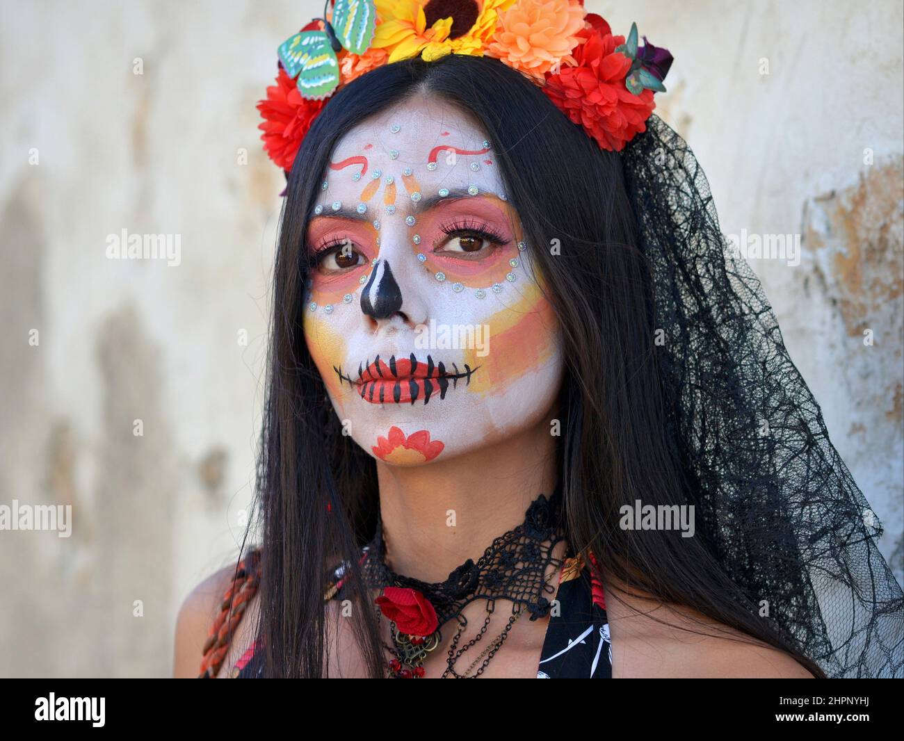 Young beautiful Caucasian woman with spooky traditional face painting ...
