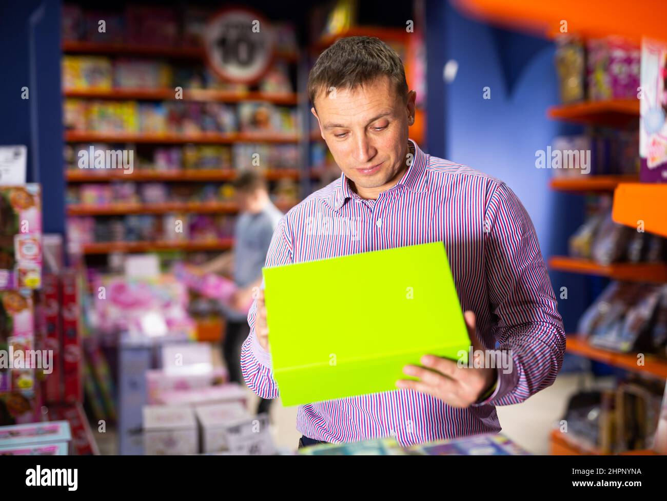 Man buying toys in store Stock Photo - Alamy