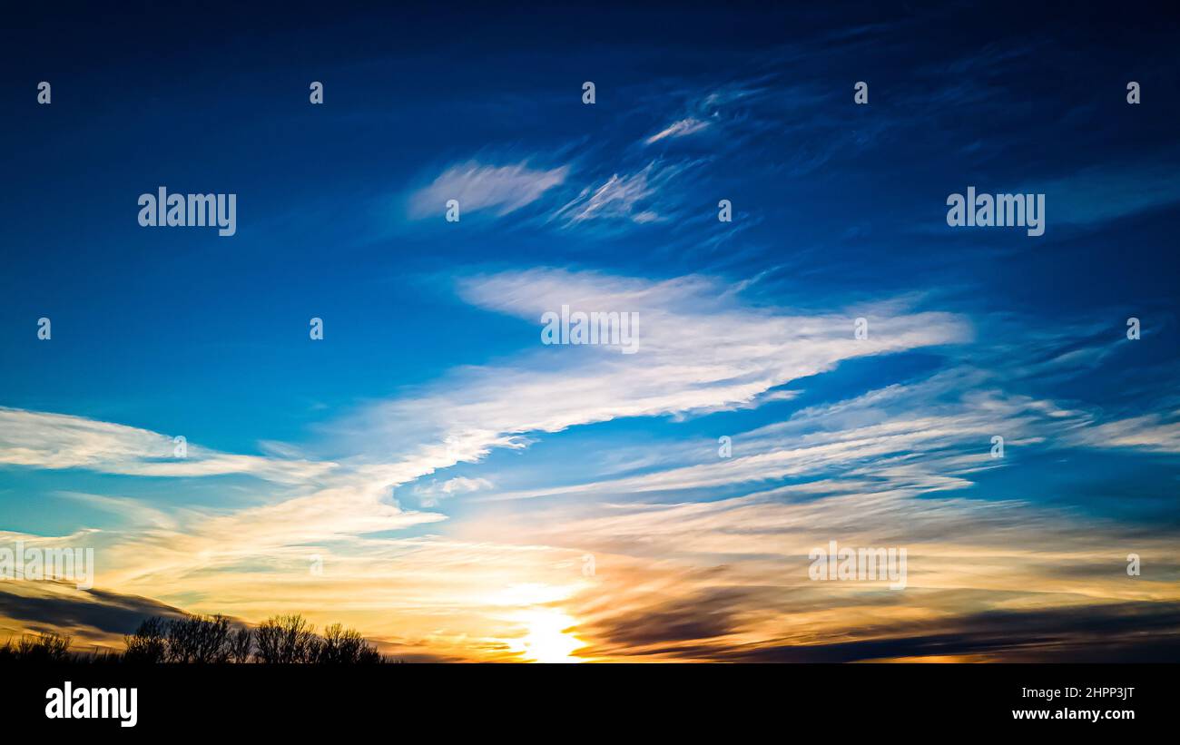 A majestic winter sunset with clouds like wings Stock Photo - Alamy