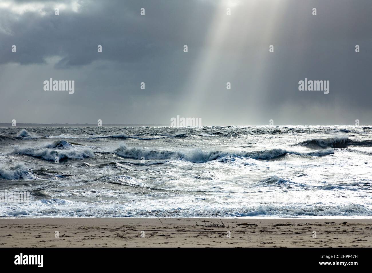 sea landscape with huge waves and sunbeam at the island of Sylt ...